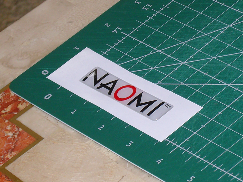 "Naomi Board Logo Doming Sticker" (SEGA) reproduced for "eduardlundinxy ...