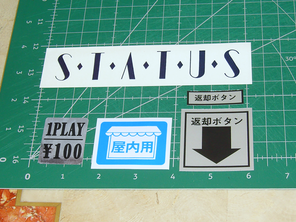 "Status Small Stickers" (CAPCOM) printed on several print materials ...