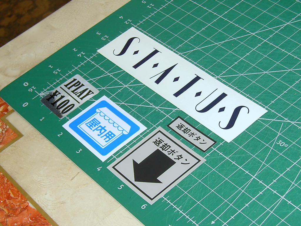 "Status Small Stickers" (CAPCOM) printed on several print materials ...